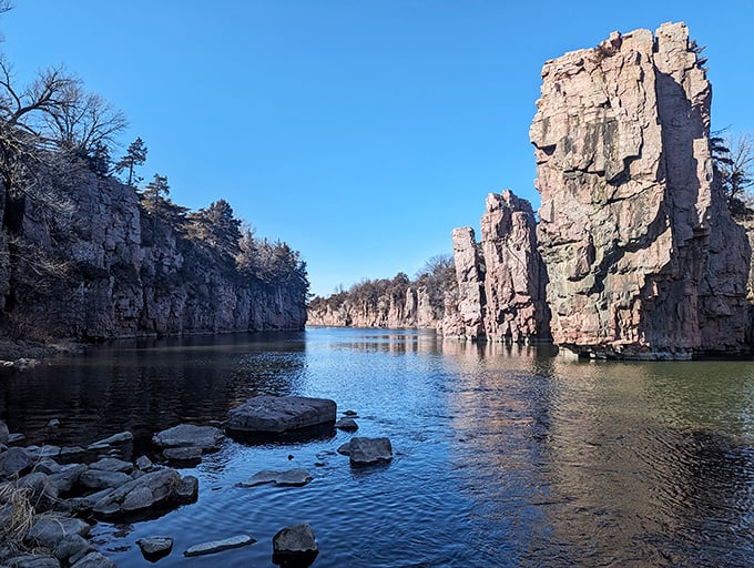 Ancient pink quartzite cliffs stand sentinel over Split Rock Creek, creating a billion-year-old masterpiece that defies South Dakota's prairie reputation.