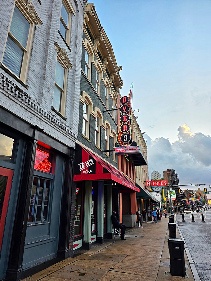 The iconic Dyer's neon sign beckons hungry travelers on Beale Street like a lighthouse for the gastronomically adrift. Memphis magic in architectural form.