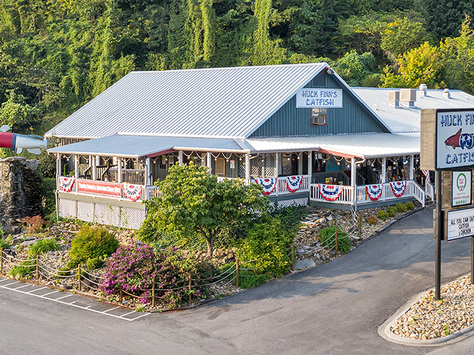 Nestled against the Smoky Mountain backdrop, Huck Finn's blue exterior and wrap-around porch beckon like a cool oasis on a hot Tennessee day.