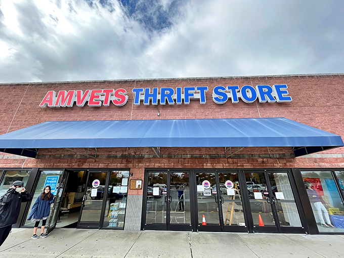 The iconic brick facade and bold blue awning of AMVETS Thrift Store stands as a beacon for bargain hunters across Knoxville.