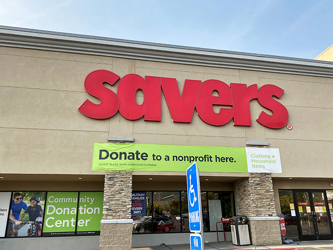 The iconic red Savers sign beckons like a lighthouse for the budget-conscious, promising treasures within those unassuming beige walls.