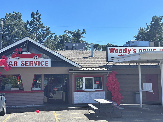 The classic red exterior of Woody's Drive-In stands as a beacon of burger bliss in Murray, where time seems to have stood deliciously still.