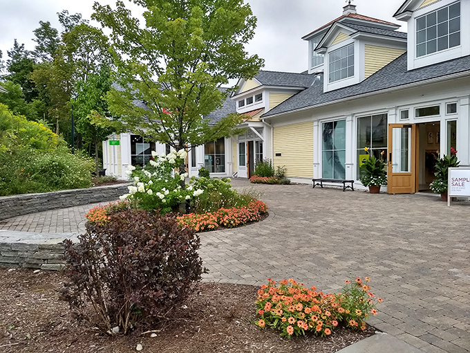 New England charm meets retail therapy at Manchester Designer Outlets, where cobblestone pathways and colorful gardens make spending money feel downright virtuous.