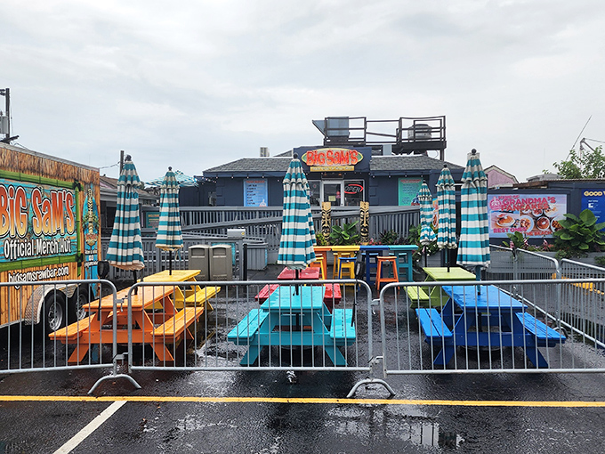 Blue skies frame the navy exterior of Big Sam's, where those distinctive tiki posts stand sentinel, promising authentic coastal flavors without the fuss.