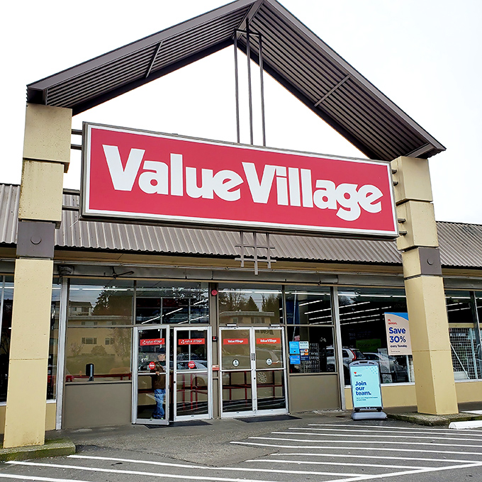 The iconic red sign beckons like a lighthouse for bargain hunters. Value Village's distinctive triangular entrance has become a symbol of thrifting adventure in Burien.