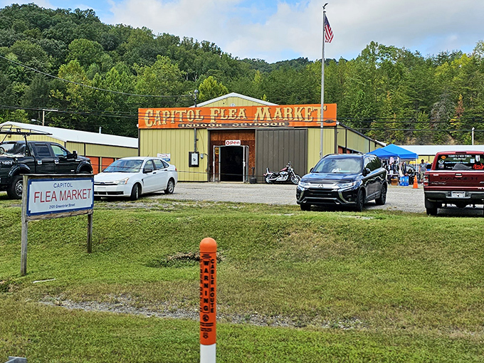 The unassuming entrance to Capitol Flea Market stands like a portal to treasure hunting paradise, where bargain dreams come true against the backdrop of West Virginia's rolling hills.