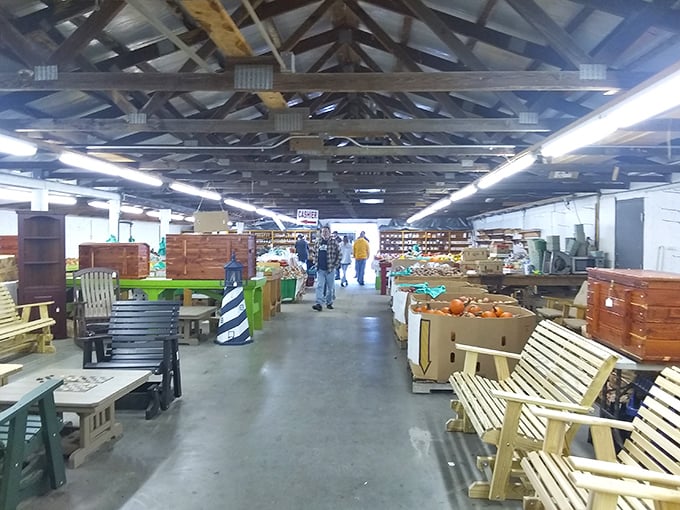 The treasure hunter's paradise! Wide aisles lined with handcrafted furniture and outdoor accessories create a bargain-seeker's dream under rustic wooden rafters.