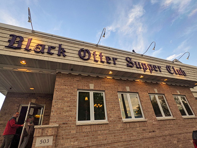 Bathed in golden evening light, the Black Otter's entrance promises the kind of Wisconsin dining experience that turns first-timers into regulars and strangers into friends.