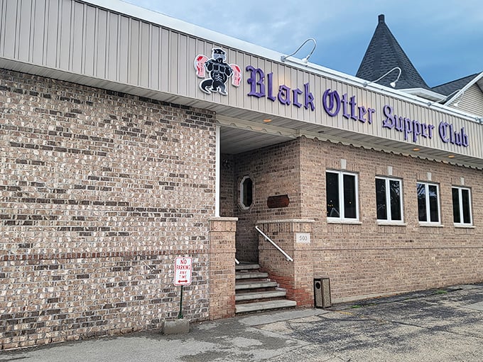 The purple lettering against brick isn't just signage—it's a beacon for hungry Wisconsinites who know that behind those doors, steak nirvana awaits.