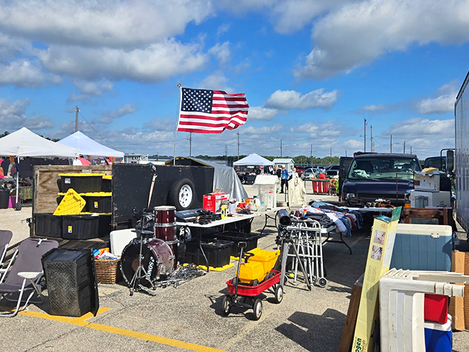 American flags wave proudly over outdoor vendor stalls where yesterday's treasures become today's unexpected finds.