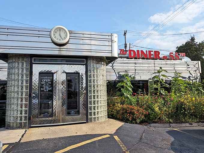 The gleaming stainless steel exterior of Diner on 55th shines like a time machine to the golden age of roadside dining. That red signage practically screams "good food ahead!"