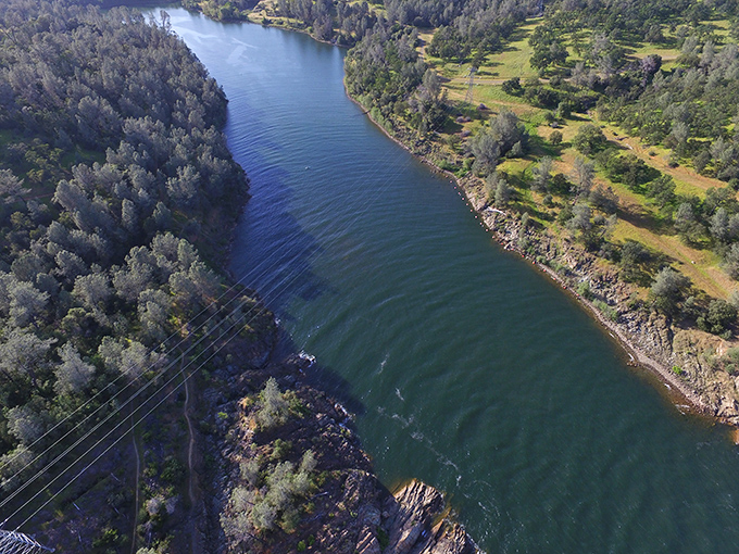 This aerial view reveals Lake Oroville's serpentine channels, where forest meets water in a dance older than disco.