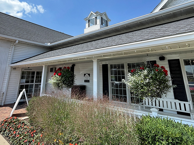 The welcoming front porch at Berlin Farmstead, where hanging flower baskets and rocking chairs invite you to slow down before the feast begins.