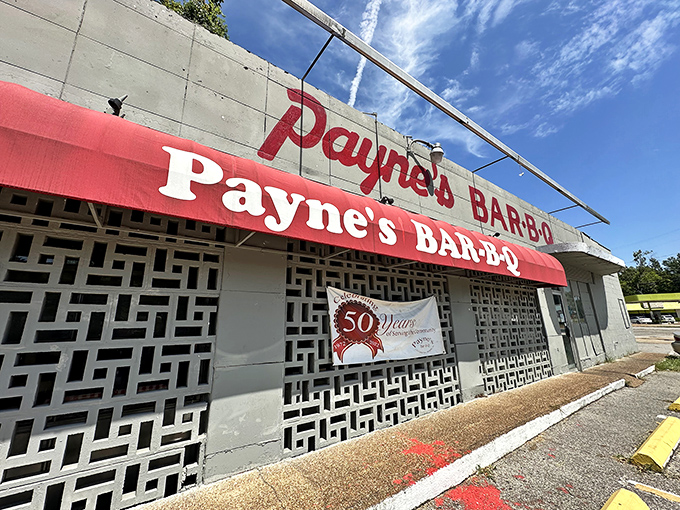 The unassuming concrete facade with its bright red awning is like a superhero's secret identity&mdash;nothing flashy, just pure barbecue greatness waiting inside.