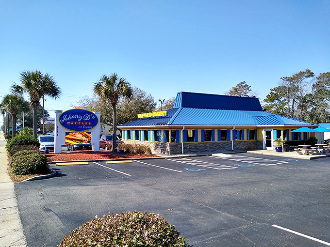 The iconic blue roof of Johnny D's stands out like a breakfast beacon, promising waffle wonders within this cheerful Myrtle Beach landmark.