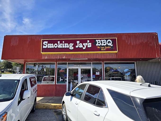The bright red exterior of Smoking Jay's BBQ stands like a beacon of hope for hungry travelers. Their motto "We Love Smokin' MEAT" isn't just signage&mdash;it's a solemn promise.