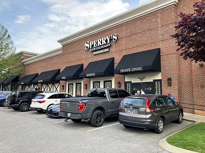 Sperry's elegant brick exterior with classic black awnings welcomes diners to Franklin's temple of timeless steakhouse perfection.