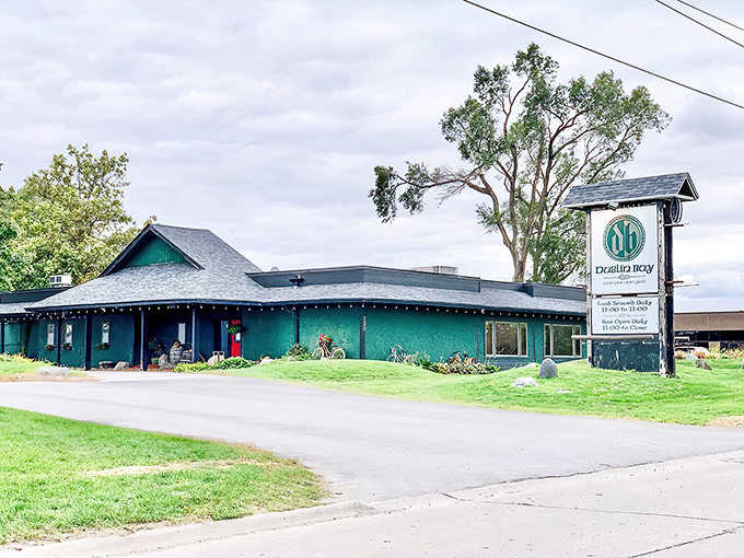 The emerald-hued exterior of Dublin Bay stands like a Celtic oasis in the Iowa landscape, promising authentic Irish comfort within its walls.