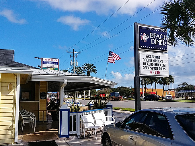 The cheerful yellow exterior of Beach Diner stands like a breakfast lighthouse, beckoning hungry souls with its no-nonsense sign and promise of early morning salvation.