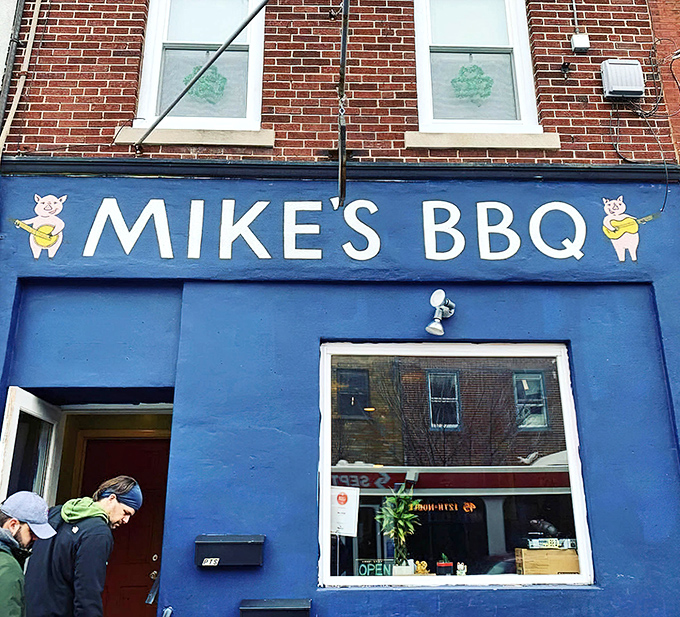 The bright blue storefront, crowned by its cheerful pig mascot, shines like a beacon of smoky promise on this South Philly block. Step inside for true BBQ salvation.