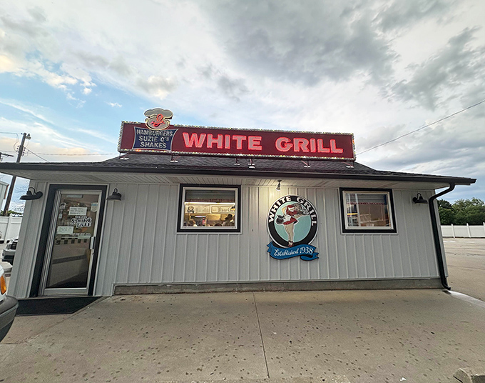 The iconic red sign of White Grill stands proud against the Missouri sky, a beacon of burger bliss since 1938.