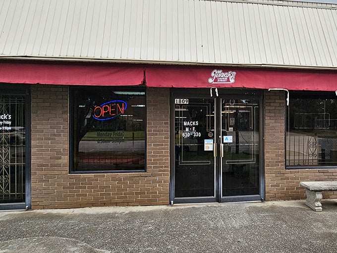 The unassuming brick exterior of Mack's Cash Grocery is like finding a paperback classic at a yard sale—modest packaging, timeless treasure inside.