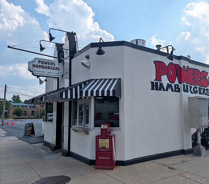 The iconic white building with its bold red lettering stands like a time capsule of American burger history, beckoning hungry travelers with simple promises.