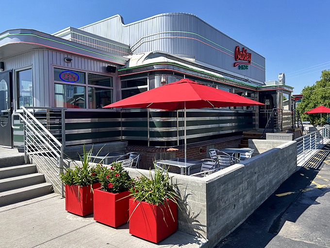 Sunlight glints off chrome and bright red umbrellas at this classic diner, where retro charm meets all-day comfort food. Classic Americana in broad daylight.