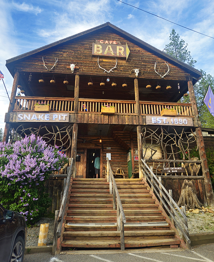 The Snake Pit's rustic log cabin exterior isn't just Instagram-worthy&mdash;it's a time portal to Idaho's wild frontier days, complete with antlers and blooming lilacs.