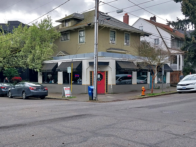 The unassuming exterior of Stepping Stone Cafe, with its coral door beckoning like a secret entrance to comfort food paradise.