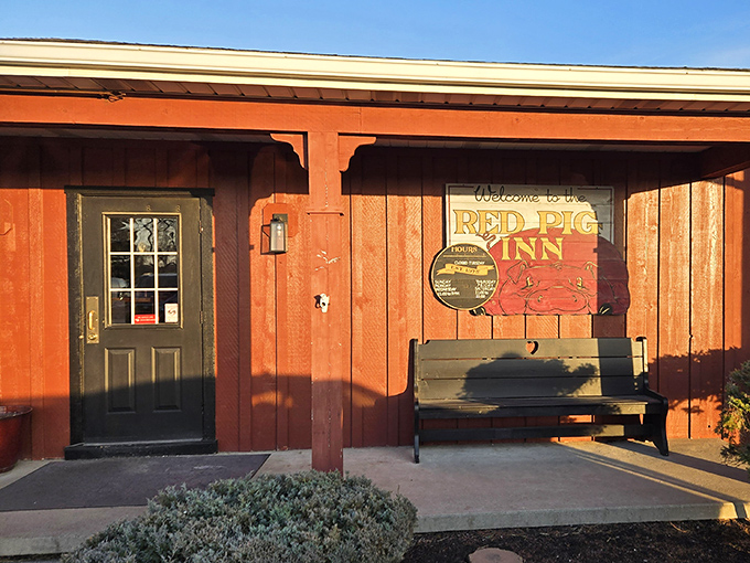 The welcoming red exterior of Red Pig Inn beckons like an old friend, promising smoky delights within those humble walls.