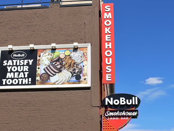 The bold red "SMOKEHOUSE" sign beckons like a barbecue lighthouse, promising smoky treasures within. "Satisfy Your Meat Tooth" isn't just clever wordplay&mdash;it's a mission statement.