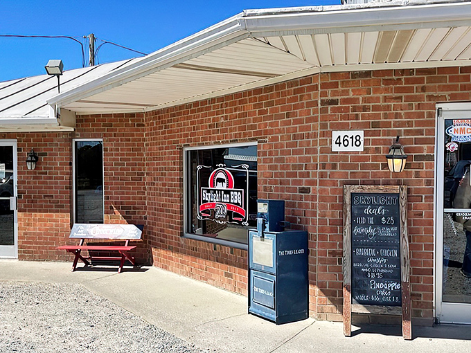 The unassuming brick exterior of Skylight Inn BBQ might not scream "world-famous," but that chalkboard menu and picnic bench whisper "get in line now, thank me later."