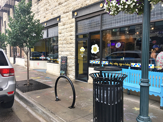 The Chef's inviting limestone exterior and cheerful blue benches welcome hungry visitors to Manhattan's beloved breakfast destination.