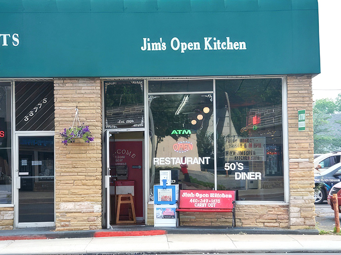 The classic red awning proudly announces "JIM'S OPEN KITCHEN" to passersby, a siren call to those seeking refuge from chain restaurant mediocrity and avocado toast overload.