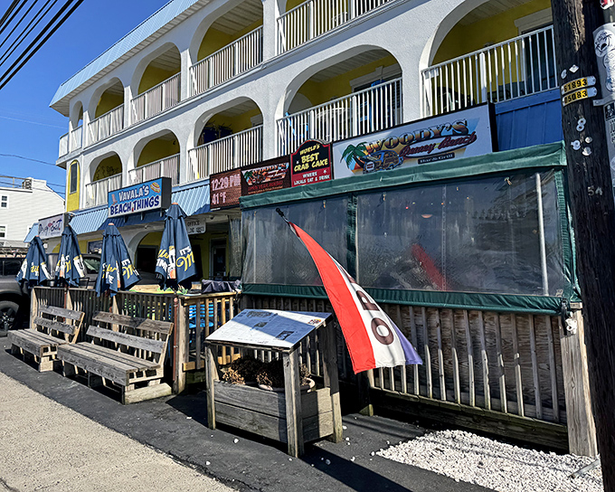 Woody's unassuming exterior hides culinary treasures within, like a beachside speakeasy that traded passwords for crab cakes.