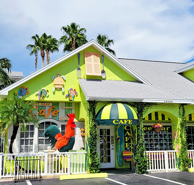 Palm trees frame the cheerful lime-green cottage where colorful fish sculptures and a proud rooster announce Florida's favorite brunch spot.