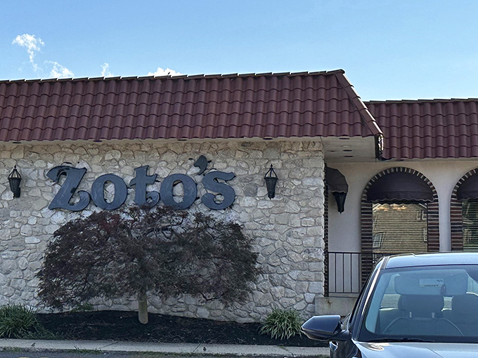 The stone facade and burgundy roof of Zoto's Diner stands like a culinary lighthouse on Bethlehem Pike, beckoning hungry travelers with promises of comfort food perfection.