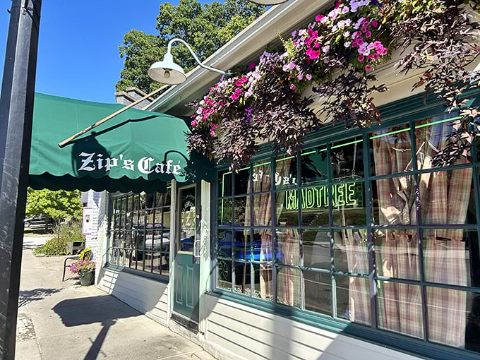 The charming exterior of Zip's Cafe welcomes you with vibrant flower boxes and that iconic green awning&mdash;like a friendly neighbor who always has something delicious cooking.
