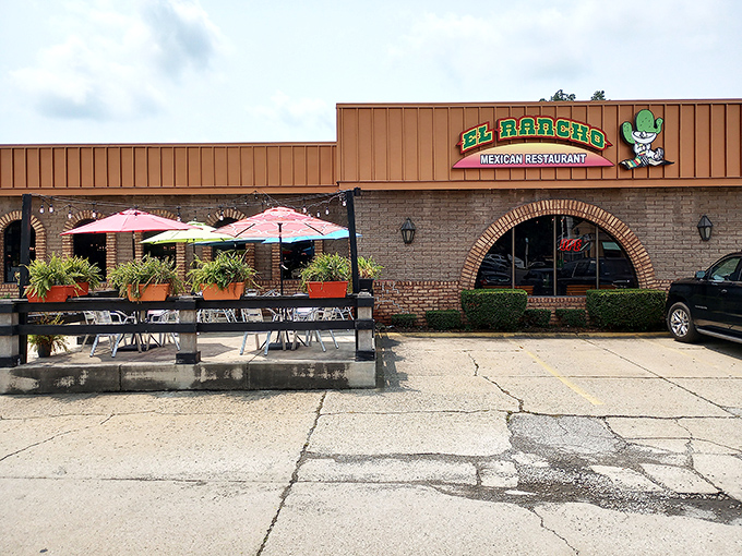 El Rancho's unassuming exterior hides culinary treasures like a pi&ntilde;ata saves its candy. Those colorful umbrellas hint at the fiesta waiting inside.