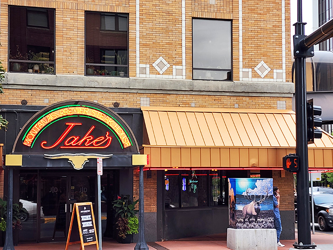 Jake's iconic neon sign glows like a beacon for beef lovers, promising Montana-sized portions and downtown Billings charm beneath that distinctive longhorn logo.