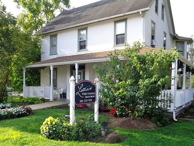A storybook farmhouse that promises comfort before you even step inside. This welcoming porch practically whispers "come get some chicken" as you pull up.
