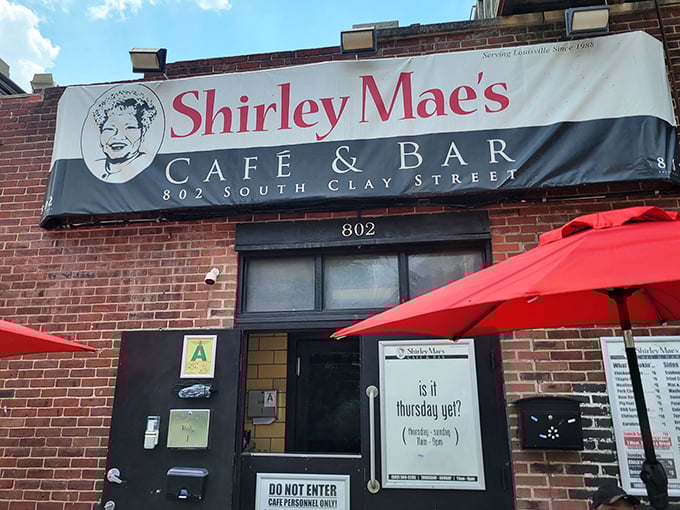 The unassuming brick facade of Shirley Mae's Caf&eacute; & Bar stands as Louisville's culinary time capsule, promising soul food treasures behind its modest exterior.