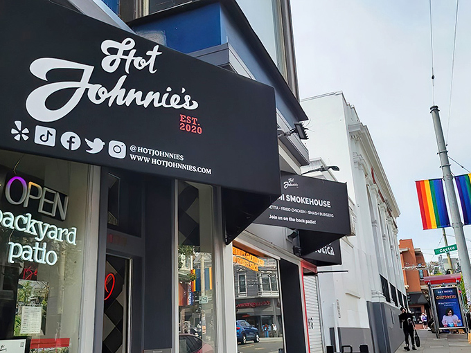 Hot Johnnie's modest storefront belies the flavor explosion waiting inside. Those bright red chairs are like beacons calling to sandwich lovers everywhere.