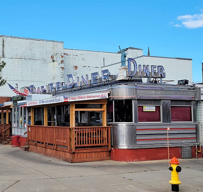 The gleaming silver exterior of Crazy Otto's Empire Diner stands like a time machine to America's golden age, complete with its own mini Statue of Liberty.