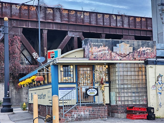 The iconic Miss Worcester Diner nestled beneath Worcester's industrial landscape, a vintage dining car with character and history.