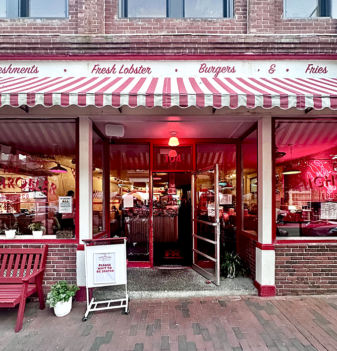 The red-and-white striped awnings of Highroller Lobster Co. pop against Portland's historic brick buildings like a carnival for seafood lovers.