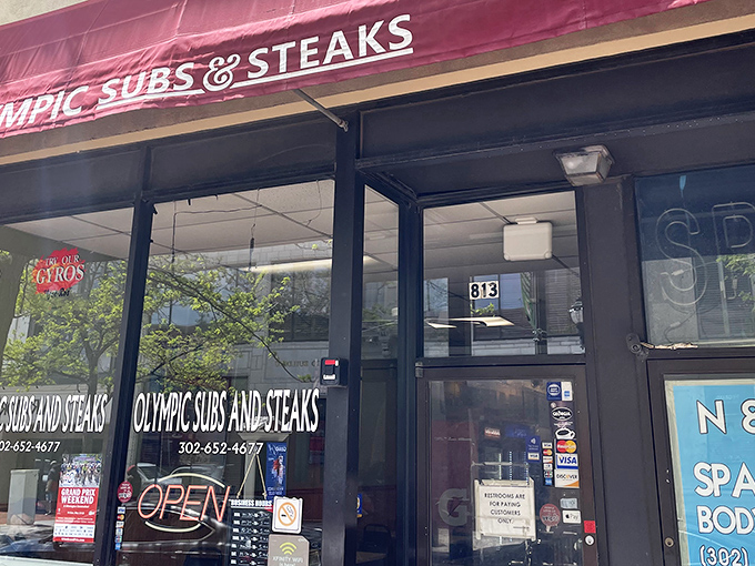 The unassuming storefront of Olympic Subs & Steaks, where sandwich greatness hides behind a humble exterior. Food treasures often lurk in the most modest packages.