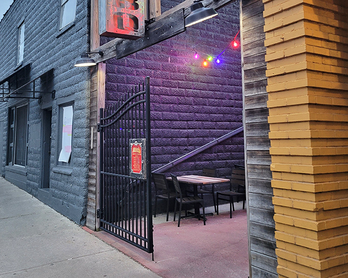 The purple-lit entrance beckons like a smoky portal to meat paradise. String lights add a touch of whimsy to this unassuming BBQ sanctuary.