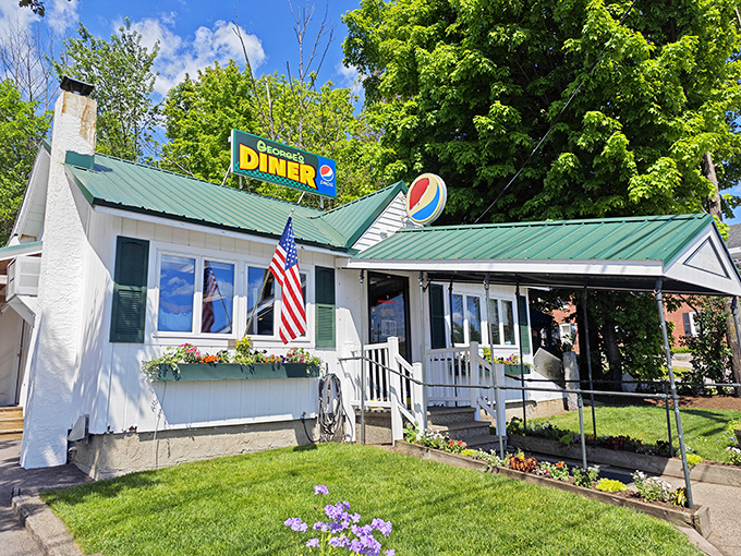 George's Diner stands proudly under summer skies, its classic sign and flower boxes welcoming hungry visitors to Meredith's beloved breakfast haven.